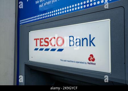 London- October 2022: Tesco Bank cash machine at a Tesco Esso petrol ...