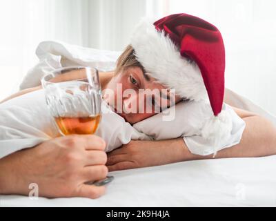 The man suffering hangover after christmas party Stock Photo - Alamy