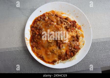 Messy plate with spaghetti full of sauce Stock Photo - Alamy