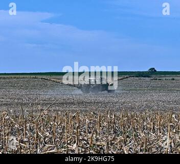 CANTON, KANSAS - SEPTEMBER 19, 2022Farm worker spraying a recently cut ...