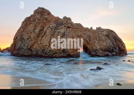 Keyhole Rock, a large, rugged rock formation with a natural archway ...
