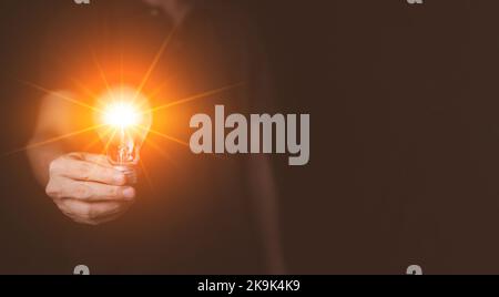 Businessman hand hold Virtual lightbulb. New ideas inspiration and ...