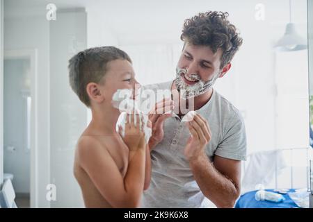 One day youll have a real beard too. a father teaching his little son ...