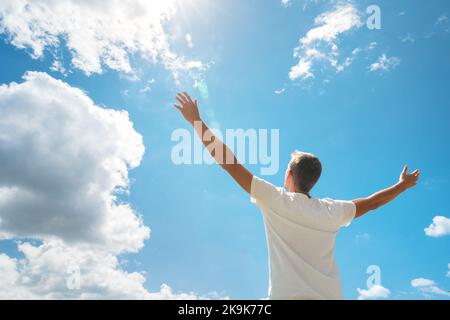 Man strive hands to the deep blue sky and sun. Religion and conceptual ...