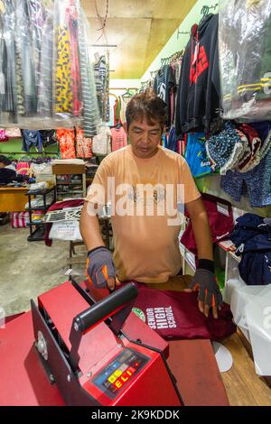 A Filipino man printing a shirt in Batangas, Philippines Stock Photo ...