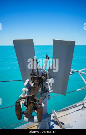 Color image of an automated machine gun on the deck of a military ship ...