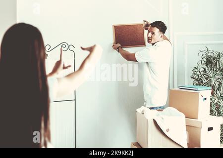 young couple arranging things in their new apartment Stock Photo - Alamy