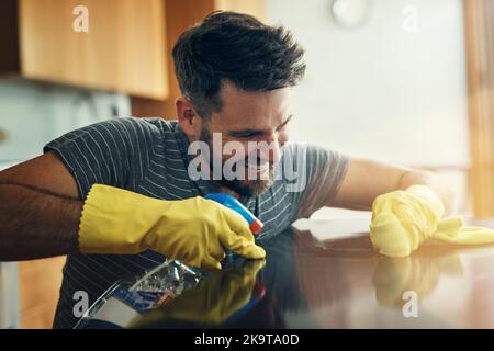 Single man cleaning kitchen at home Stock Photo - Alamy