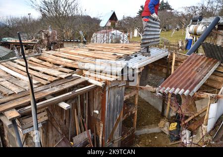 Roof workers remove metal roof during demolition Stock Photo - Alamy