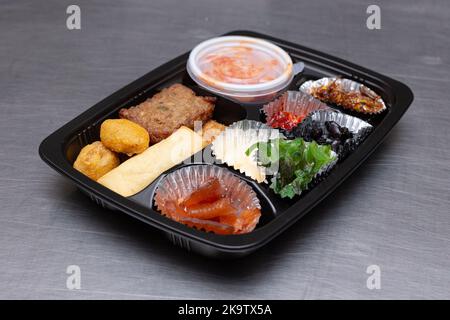 A delicious-looking lunch box with a variety of side dishes, fruits and ...