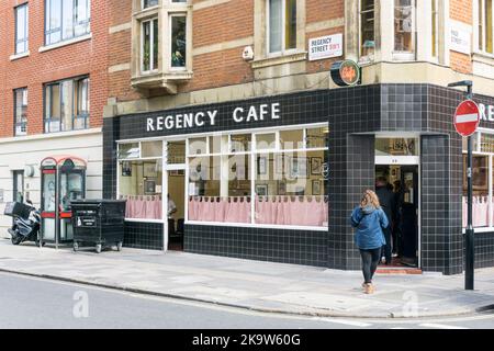 A queue outside The Regency Cafe in Regency Street, Victoria, London ...