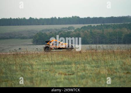 a space frame cross country buggy driving a track in open countryside ...