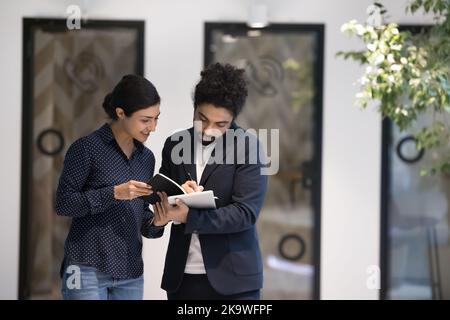 employees discuss their ideas standing in the office Stock Photo - Alamy
