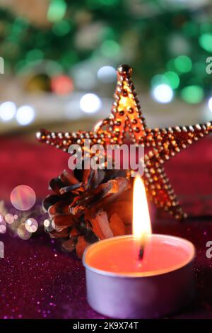 Lit Tea Light candle/Glittering Christmas Star/Pine Cone/Bokeh ...