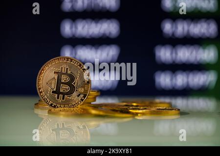 Stack or heap of gold Bitcoins cryptocurrency coins with candle stick ...