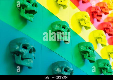 A collection of multi-colored skulls laid out in a line. Halloween ...