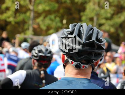 head of a cyclist with protective helmet at the start of a cycling race ...