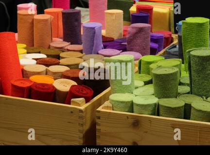 tubes of fabrics and colorful cloths and for sale in the cloth shop ...