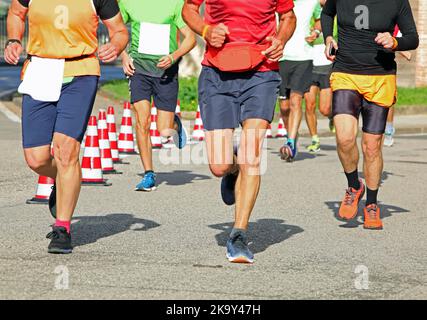 many runners run during the foot race is in the city with muscular legs ...