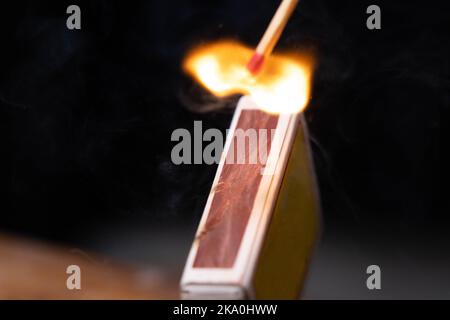 Matchstick fires on matchbox in slow motion close-up. The match was ...