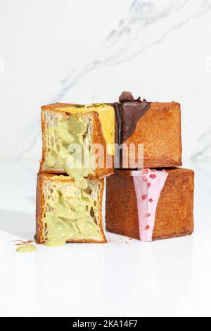 Sliced puff cube croissant with berry cream and two whole cubes with ...