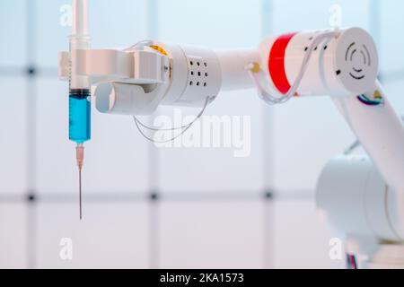 Robot hand with a medical syringe. Future medicine concept using robots ...