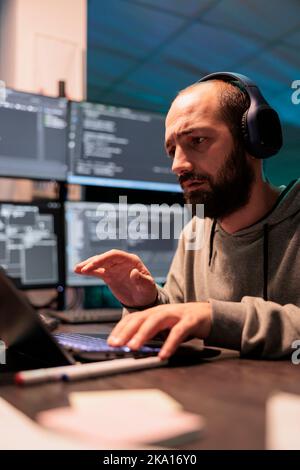 Male app developer using html script code on computer, programming new ...