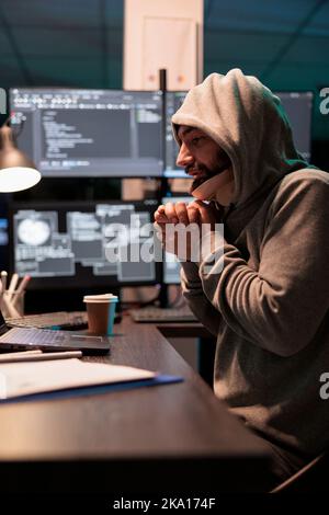 Male web developer with medical neck collar programming code in office, feeling sick after ...