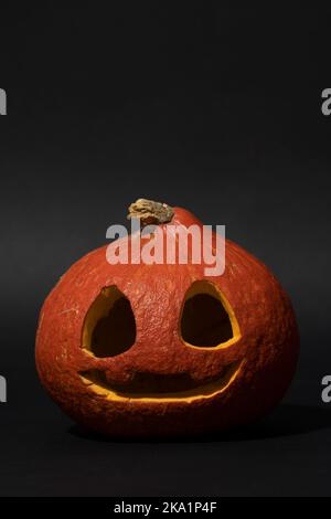 Jack-O-Lantern pumpkin on black veil near violet wall Stock Photo - Alamy