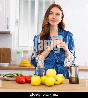 Portrait of attractive dreamy cheerful girl using netbook writing story ...