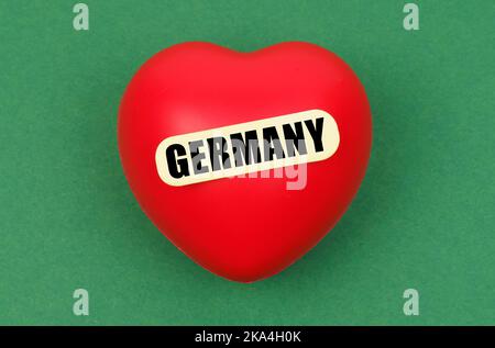 Love to motherland. On a green surface lies a red heart with the ...