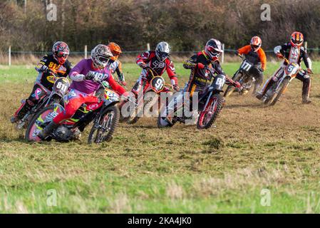 GT140 solo class riders racing in a grasstrack motorcycle race. Donut ...