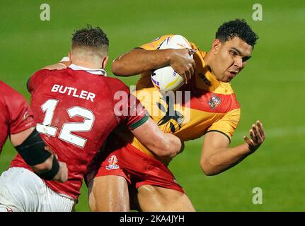 Papua New Guinea's Jacob Alick tackled by Wales' Connor Davies and Dan ...