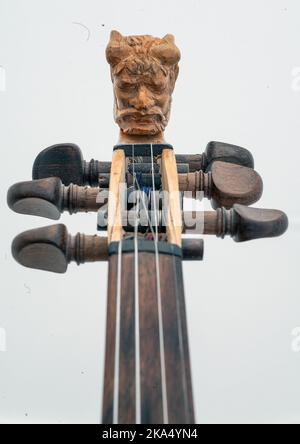 Violin scroll - carved in the shape of a lions head, with gut strings ...