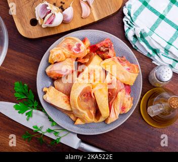 Pieces of unprepared chicken on table Stock Photo - Alamy
