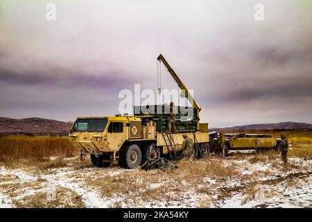 A Heavy Expanded Mobility Tactical Truck (HEMTT) is driven off a flat ...