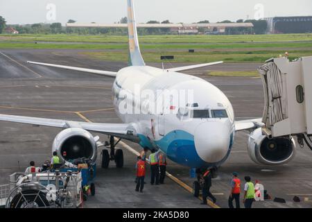 View of Merpati Airlines low cost carrier airliner on apron with ground ...