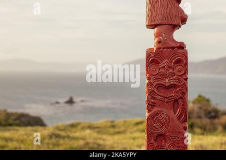 Close up of whakairo pouwhenua with background Stock Photo - Alamy