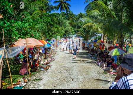 Villagers line the roadside selling handcrafts and souvenirs to vising ...