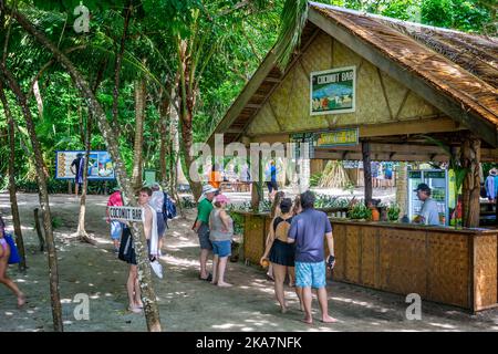 Holidaymakers queueing at beach bar, Conflict Islands, Papua New Guinea ...