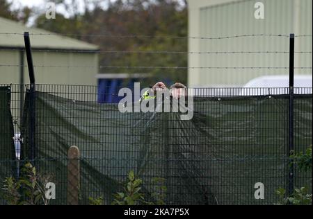 A member of security staff secures screens around the Manston ...