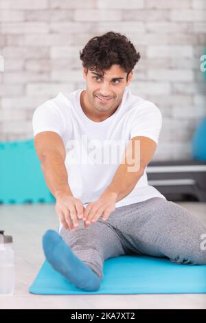 handsome young man doing hamstring stretch exercise Stock Photo - Alamy