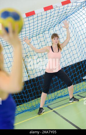 Woman defending handball goal Stock Photo - Alamy