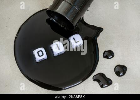 Oil crisis depiction with toys, oil barrel and spill on gray with ...