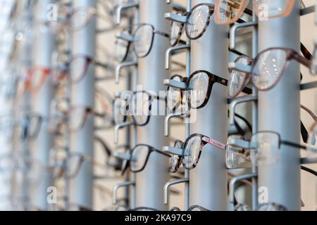 Designer spectacles or glasses frames on display in an opticians store ...