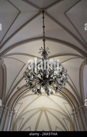 An old chandelier hangs from the ceiling of a traditional Filipino ...