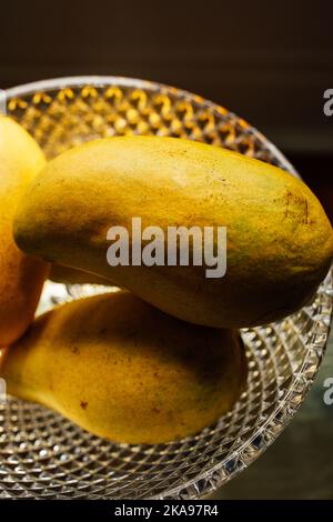 yellow champagne mango fruit in crystal bowl Stock Photo - Alamy
