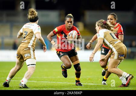 Papua New Guinea's Martha Molowia (centre) its tackled by Canada's ...
