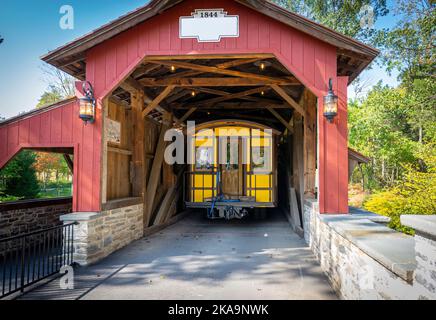 Installing a New Yellow Passenger Antique Coach Thru a Cover Bridge on ...