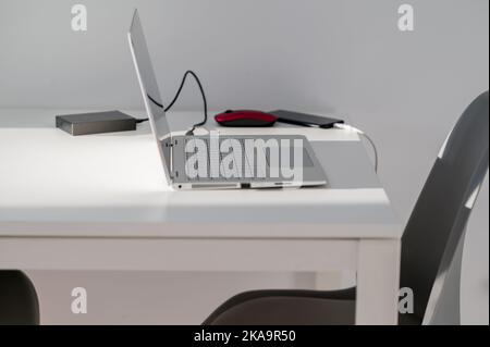 Gray Desk Setup with Laptop and Red Headphones. Blank white screen ...